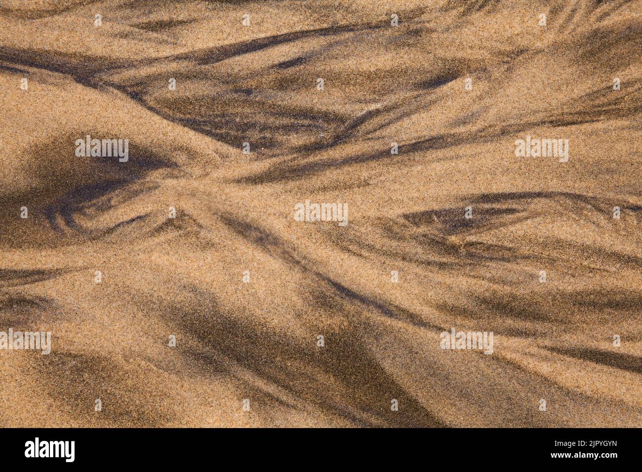 Patterns in the sand in golden light Stock Photo - Alamy