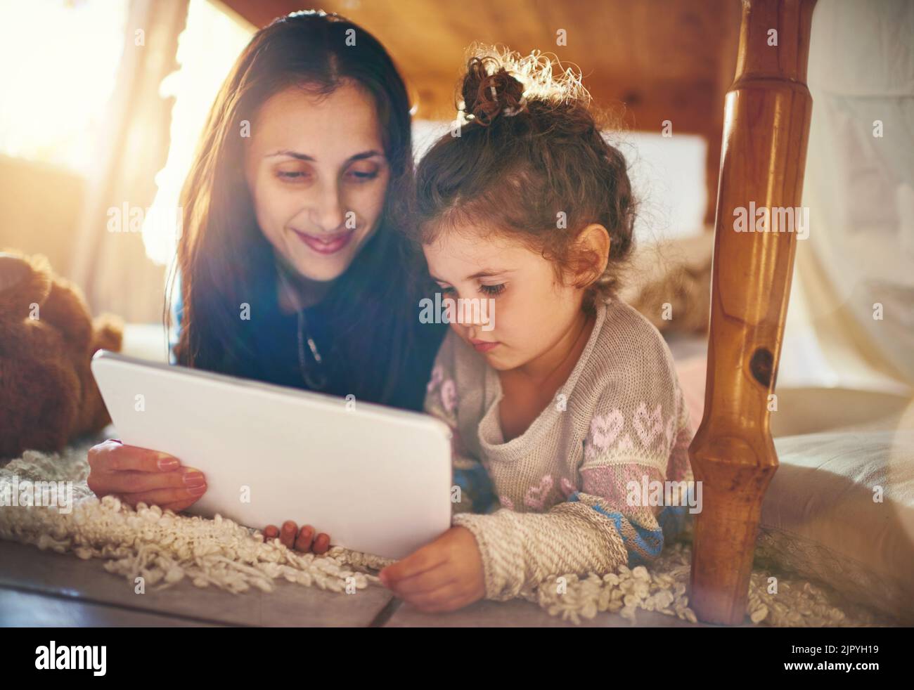 Exploring the digital world. a mother and her little daughter using a ...