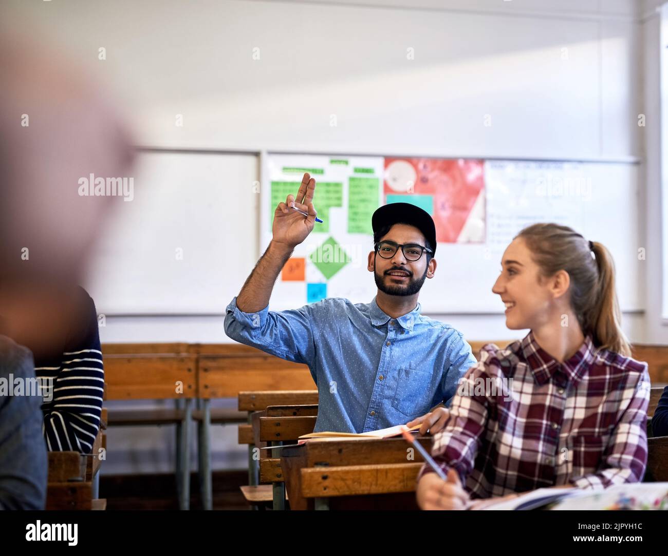 He knows the answer. an university student hand raised in class Stock ...