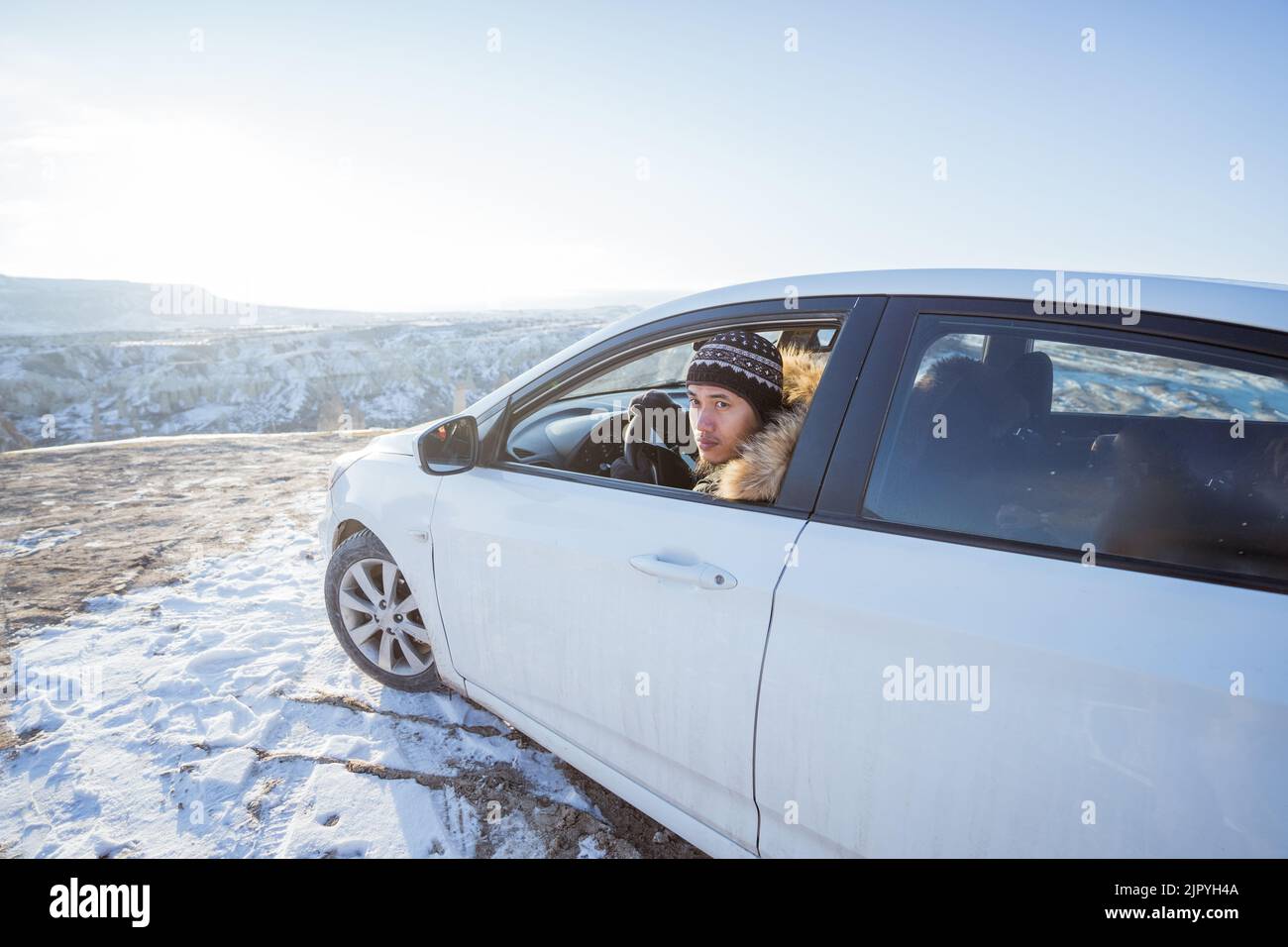 young man when getting on top of the hill by his car Stock Photo - Alamy