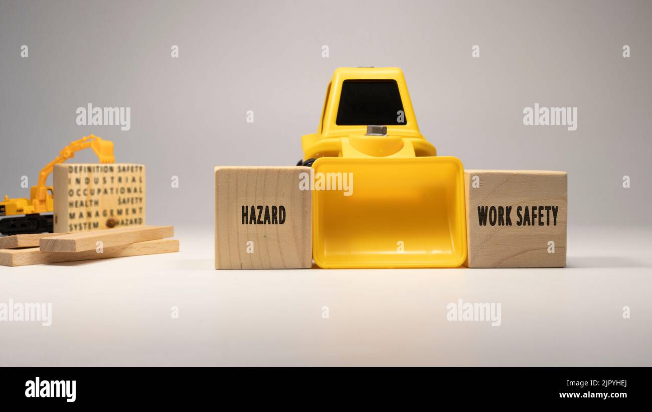 Hazard, work safety , written on wooden sticks. Business machine and ...