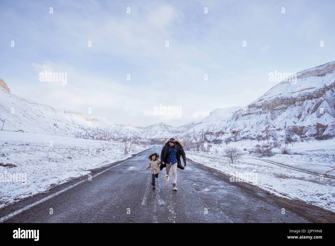 dad and daughter walking on empty street in winter Stock Photo - Alamy