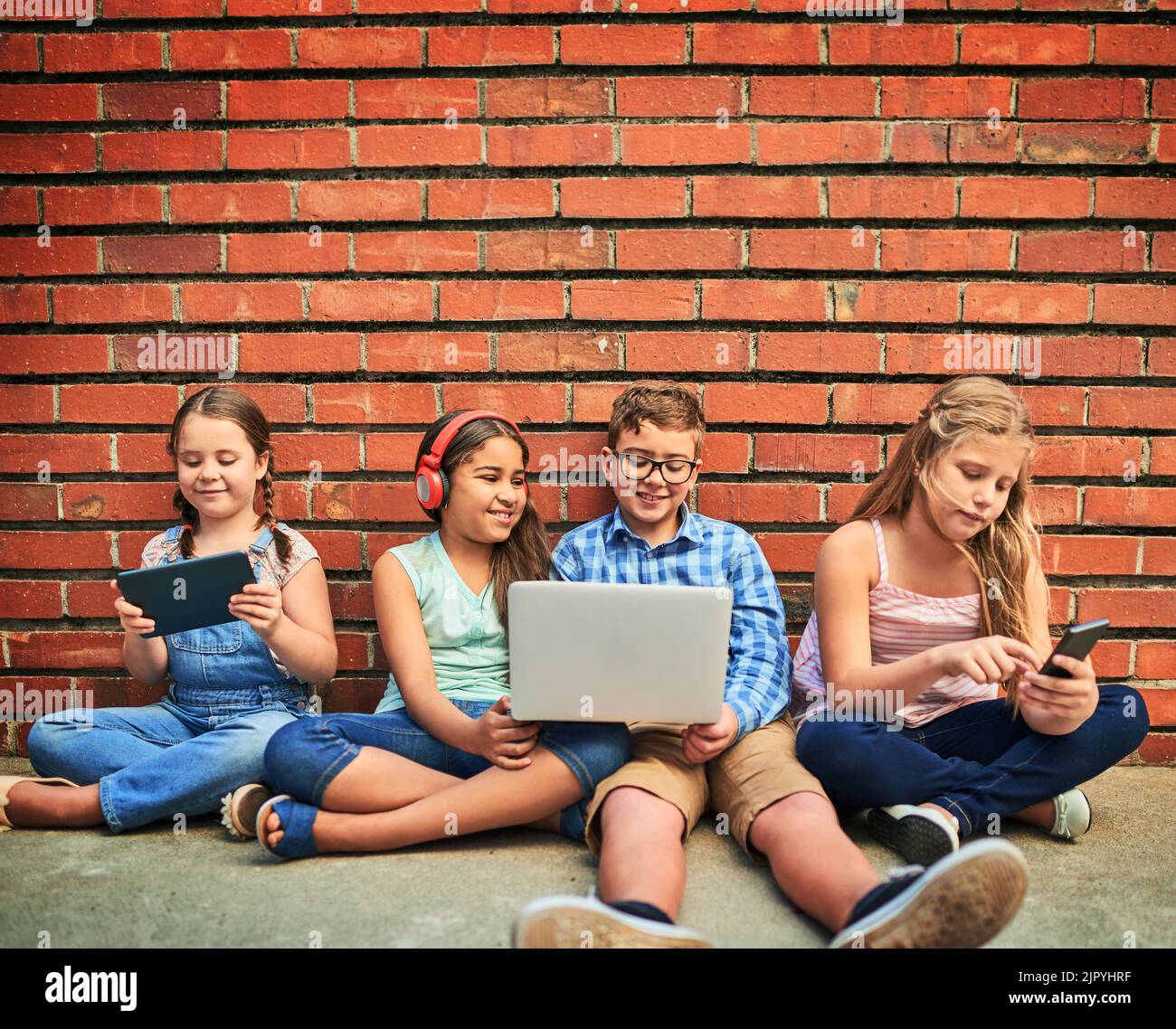 Its how we have fun. a group of young children using digital devices ...
