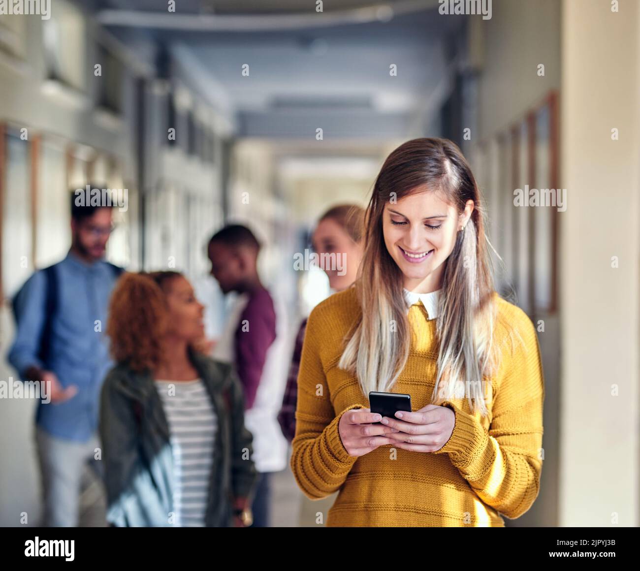 Staying connected on campus. an attractive young female university ...