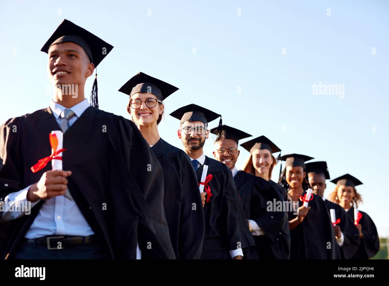 Hard work always gets rewarded. a group of university students standing ...