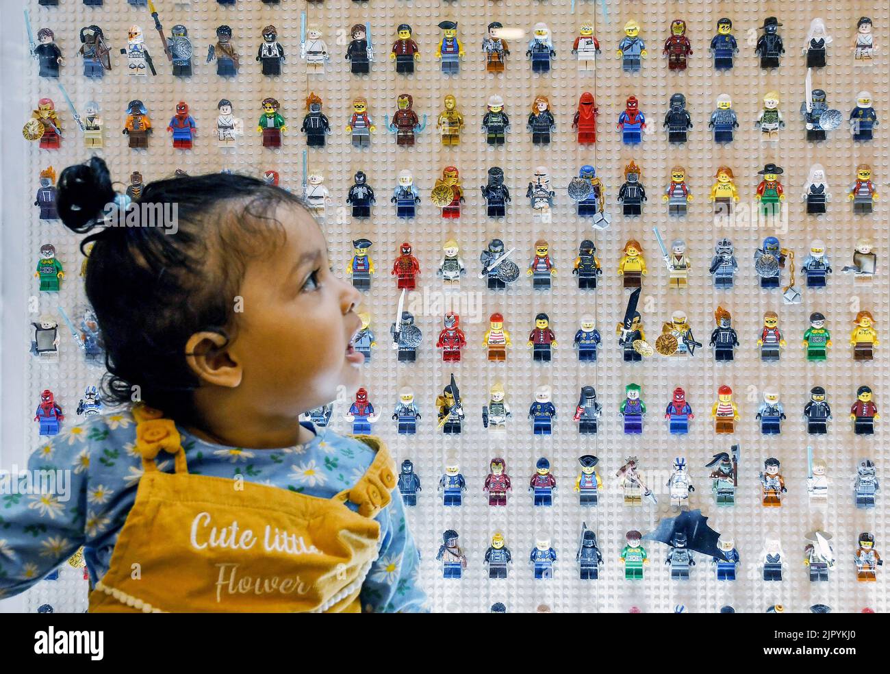 Mumbai, India. 20th Aug, 2022. A child looks at a miniature toys kept ...