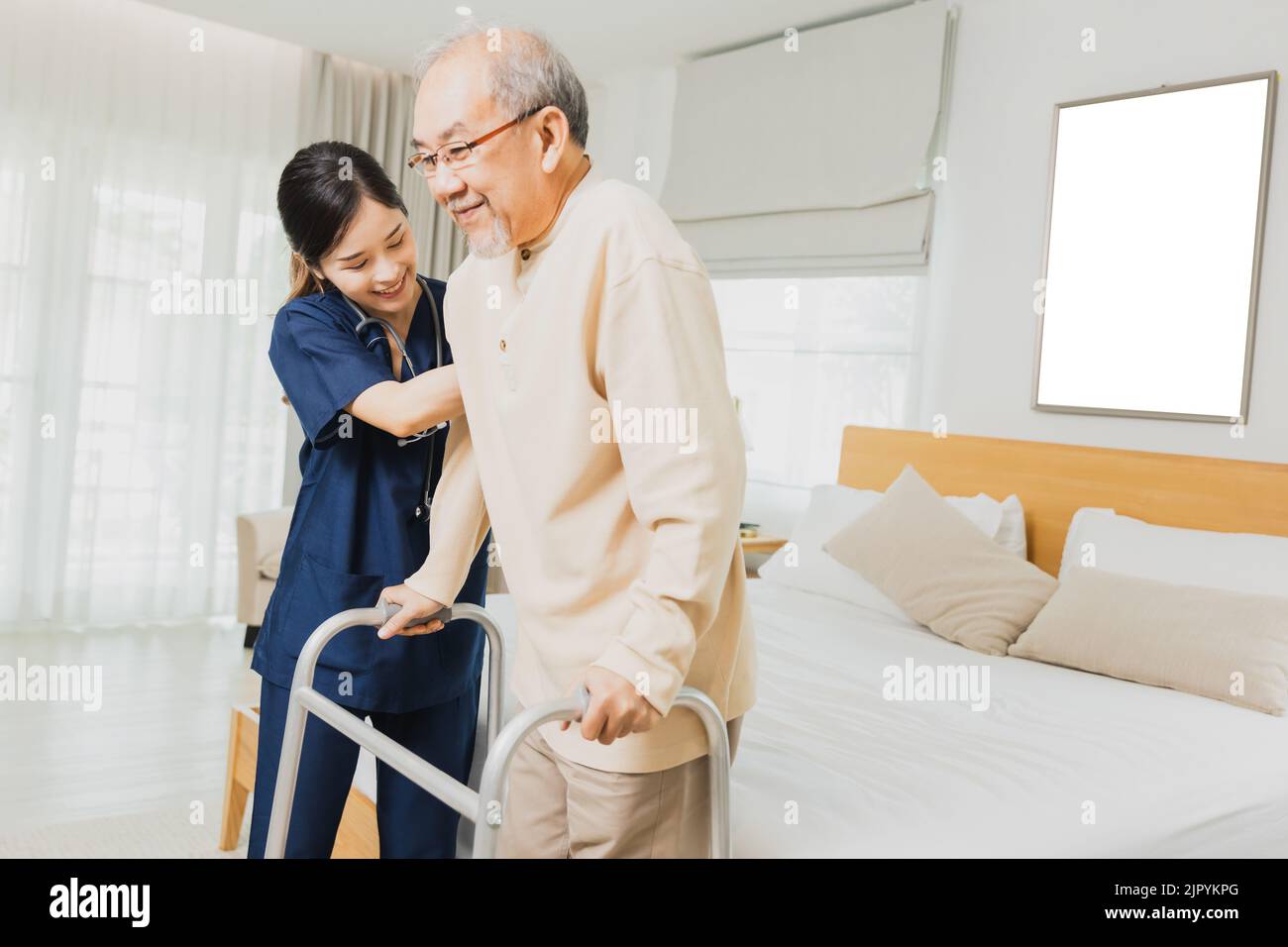 Smiling nurse woman helping senior Asian man to walk around the nursing ...