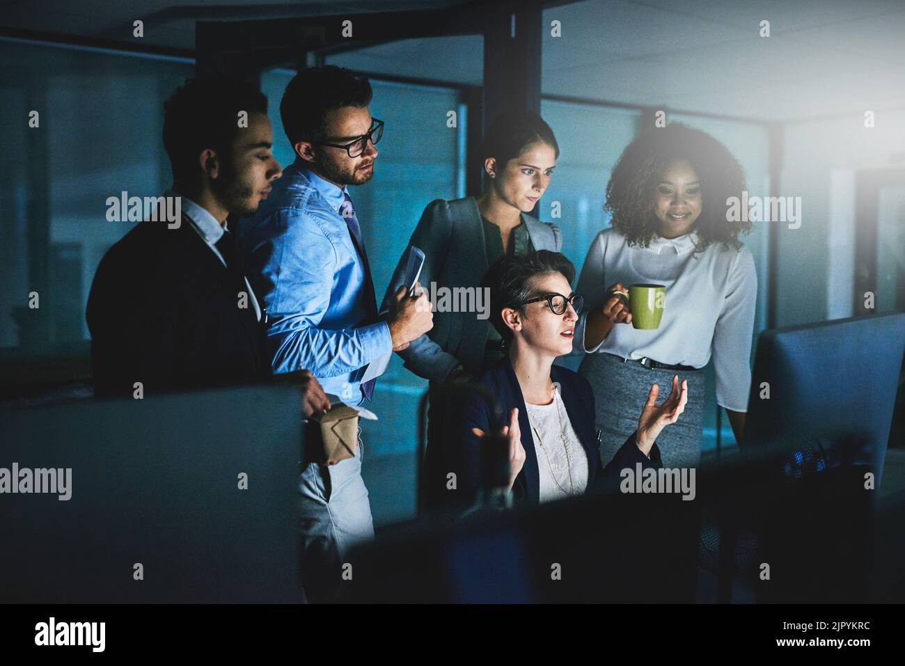 Rising to the occasion. colleagues standing together as they work on ...