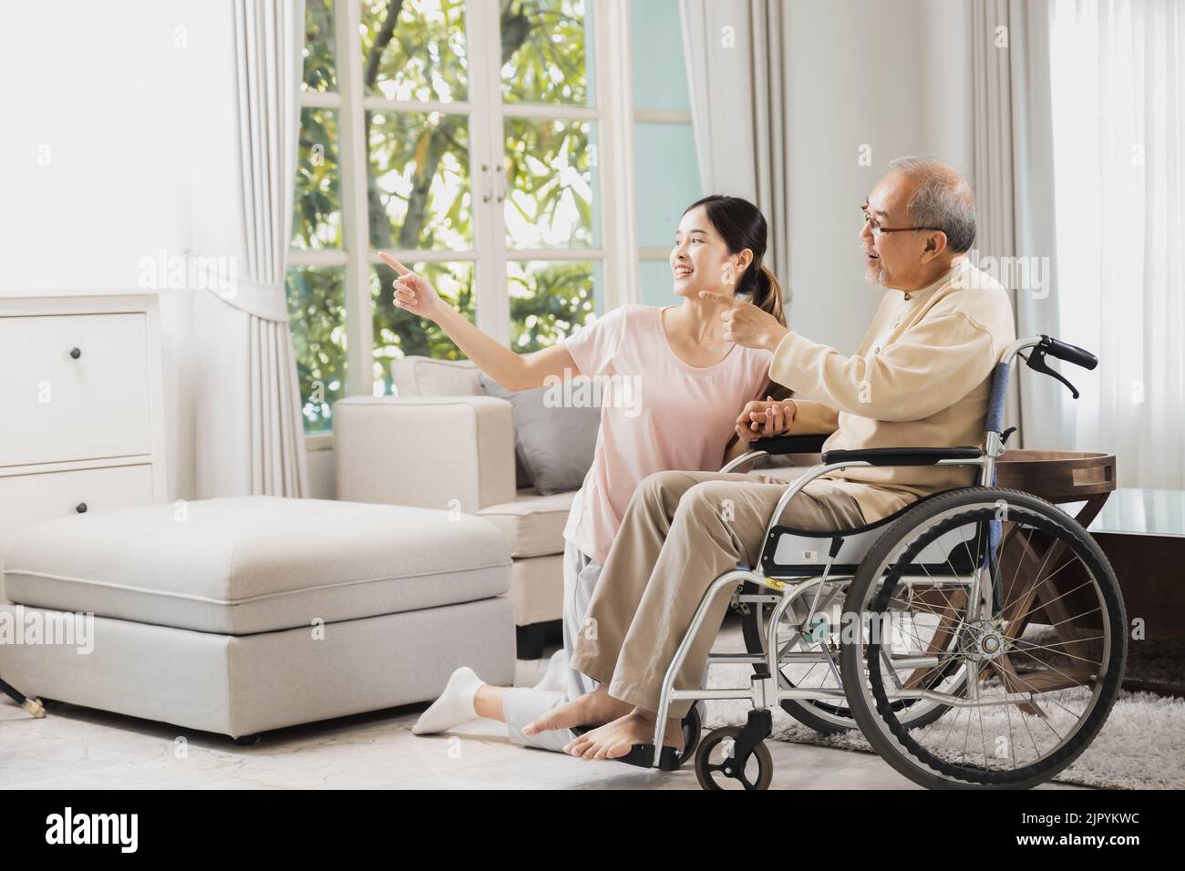 senior with beautiful daughter, old man sitting on wheelchair in house, take care elderly ...