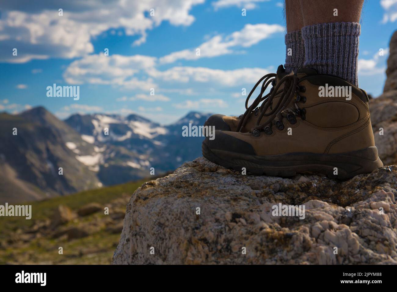 A hiker looks out on the Rocky Mountains at Rocky Mountain National ...