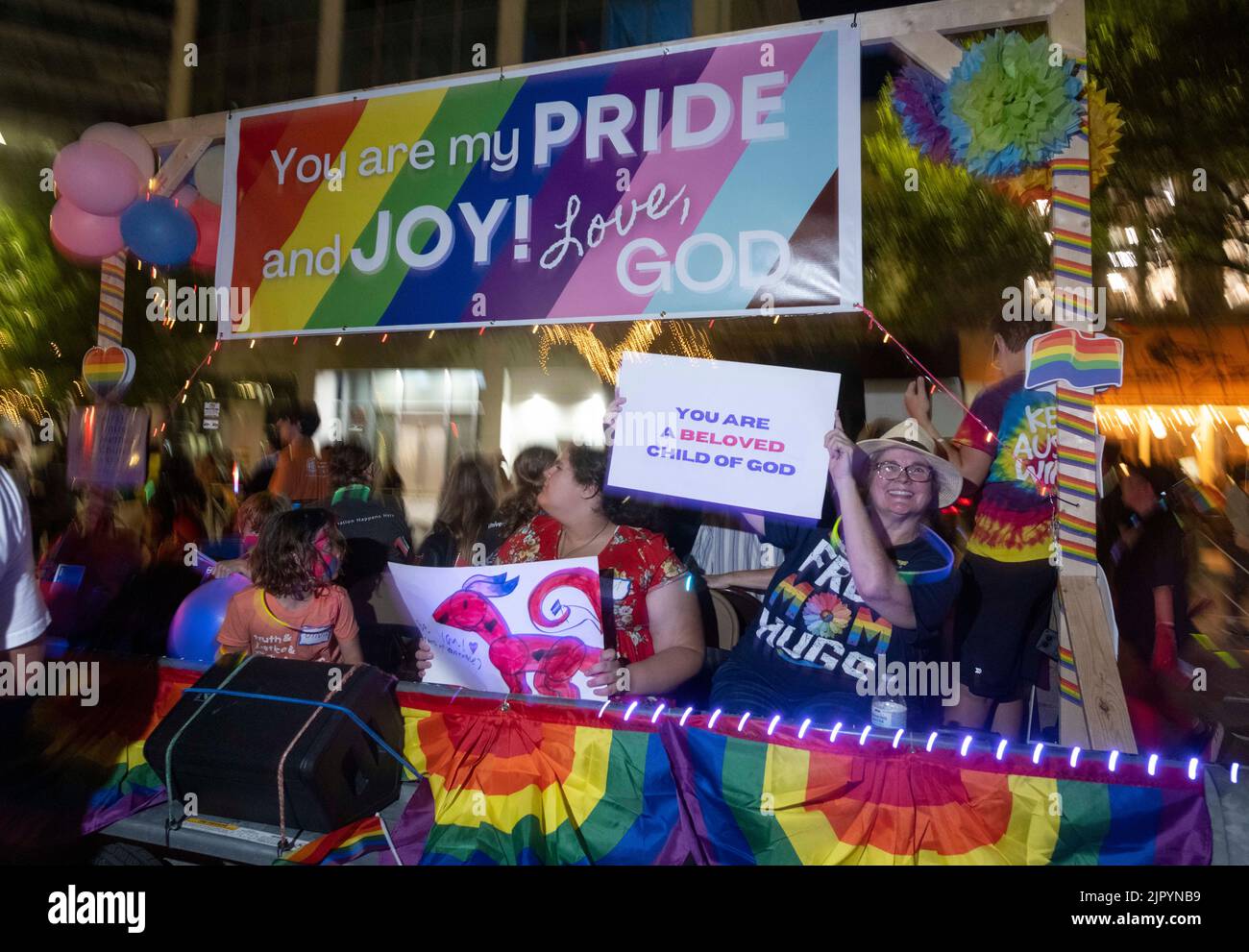 Revelers from First United Methodist Church of Austin hold signs while ...