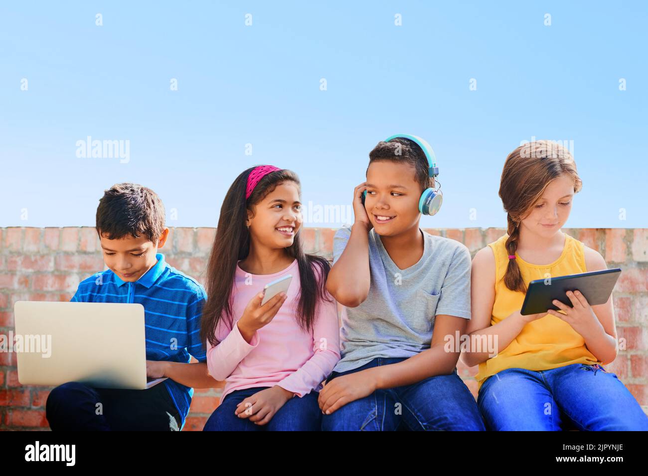 We are the digital age. a diverse group of children having fun with ...