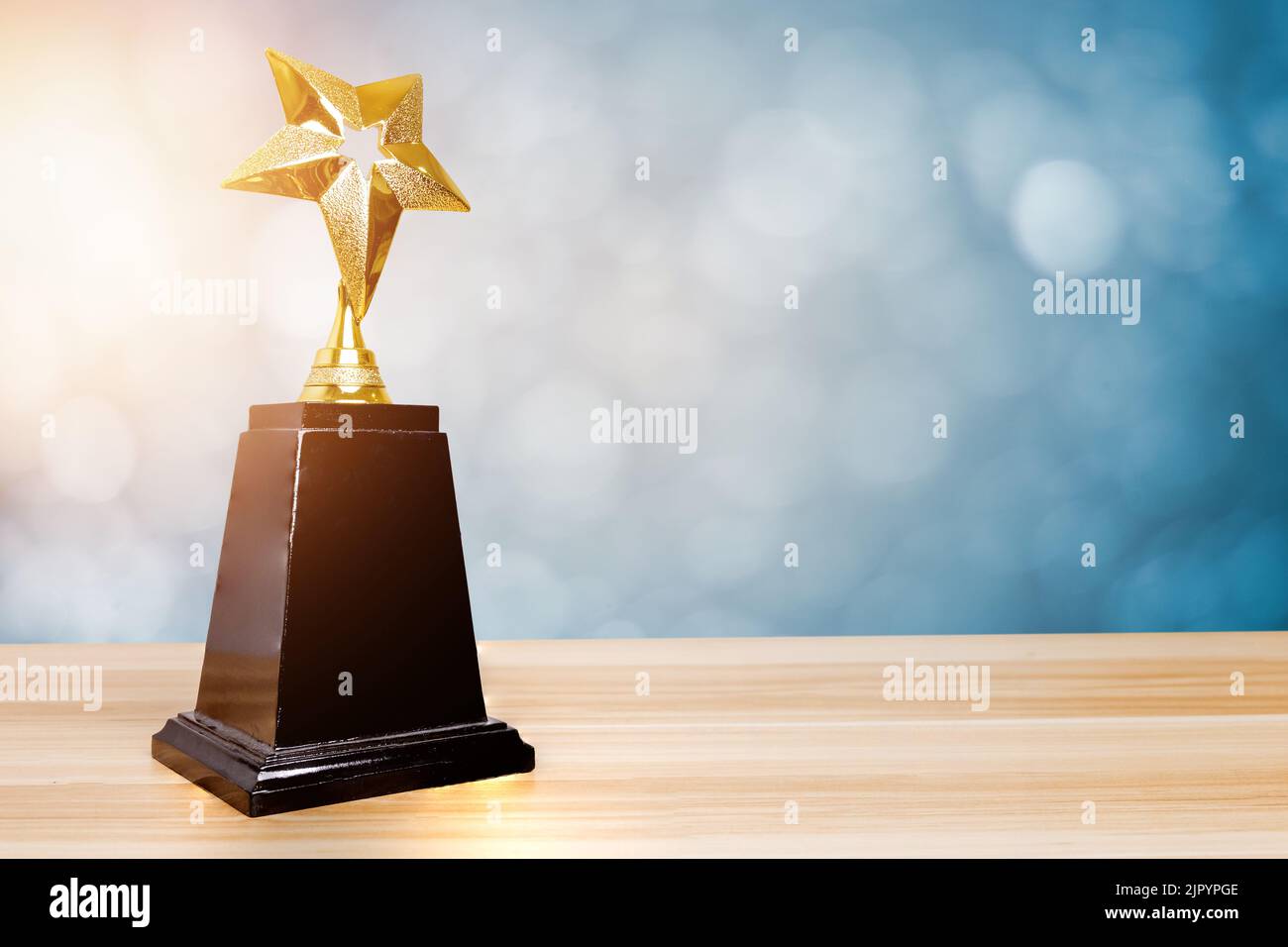 golden trophy award bokeh soft blue background. copy space for text ...