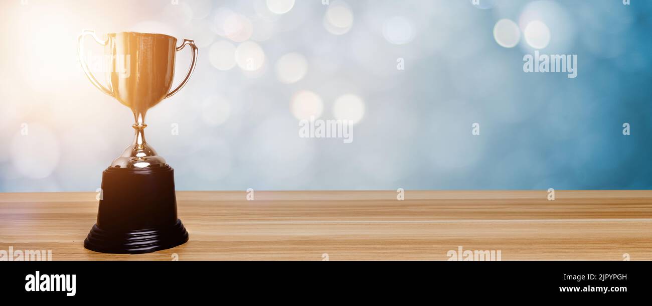 golden trophy award bokeh soft blue background. copy space for text ...