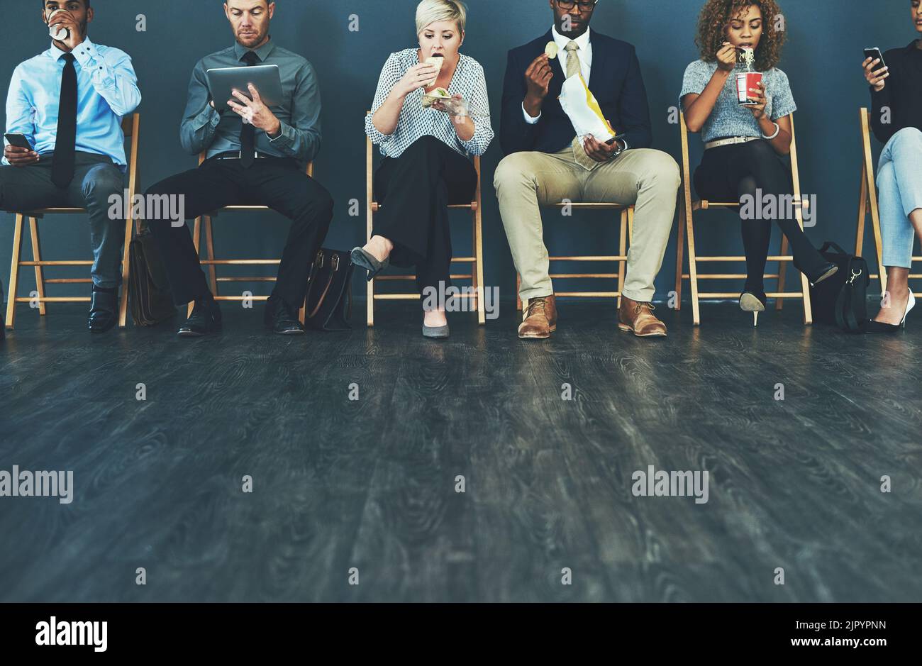 Its been a long wait. a group of well-dressed business people seated in ...