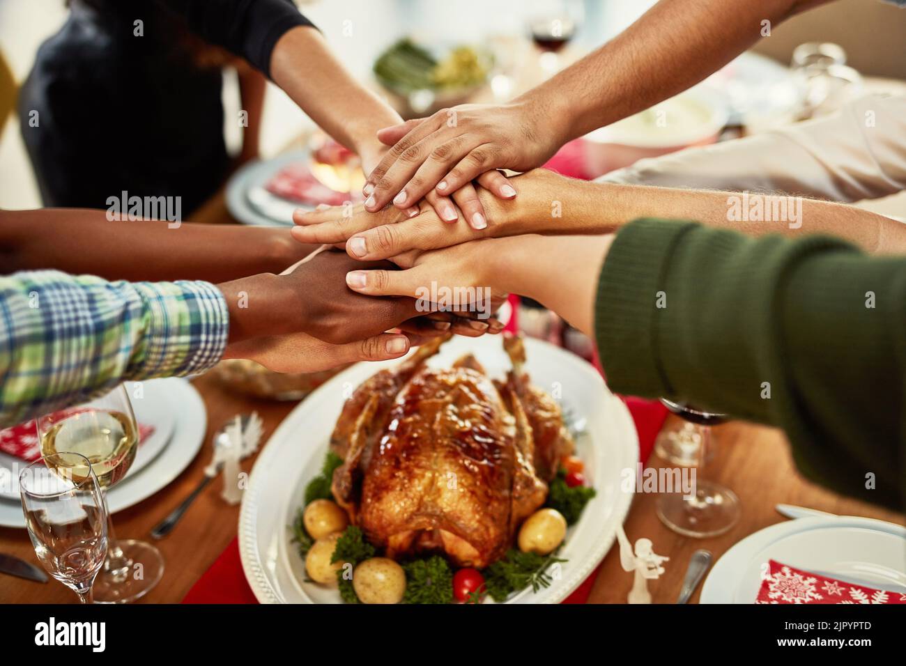 Food is what brings us together. a group of people stacking their hands ...