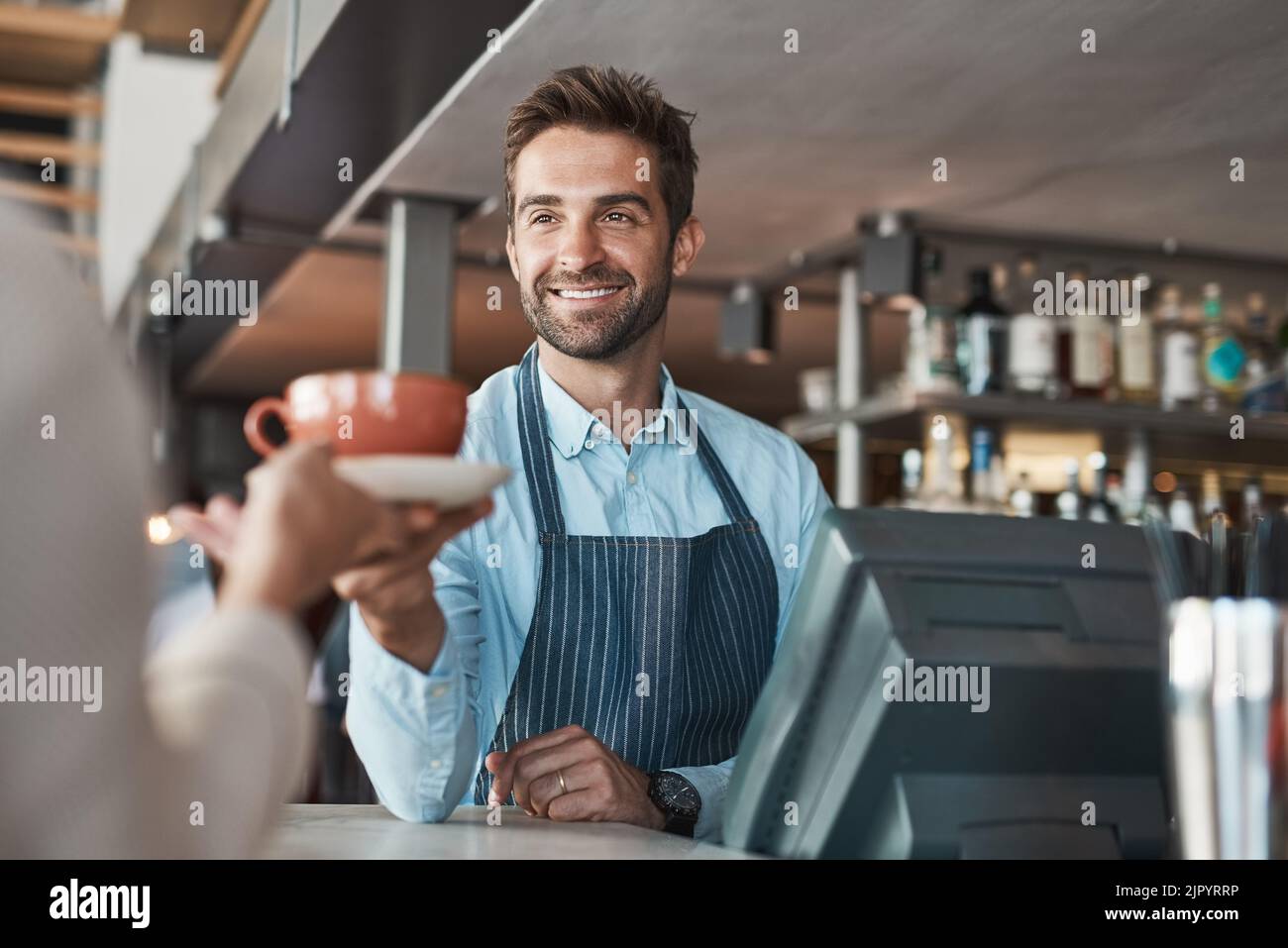 One cappuccino coming right up. a waiter serving coffee to a customer ... One cappuccino coming right up. a waiter serving coffee to a customer ...