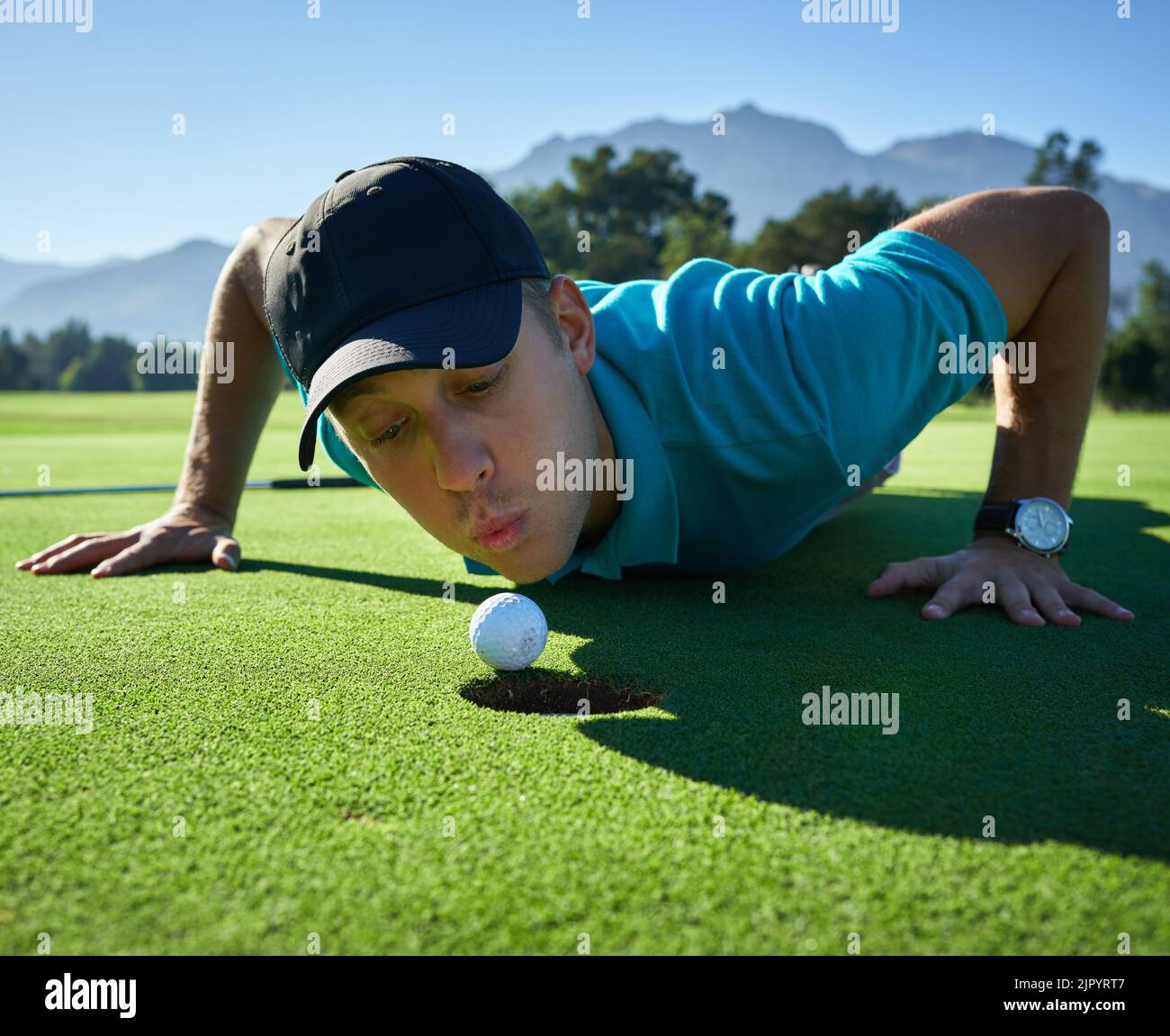 Why wont you go in. Low angle shot of a carefree young man blowing a ...