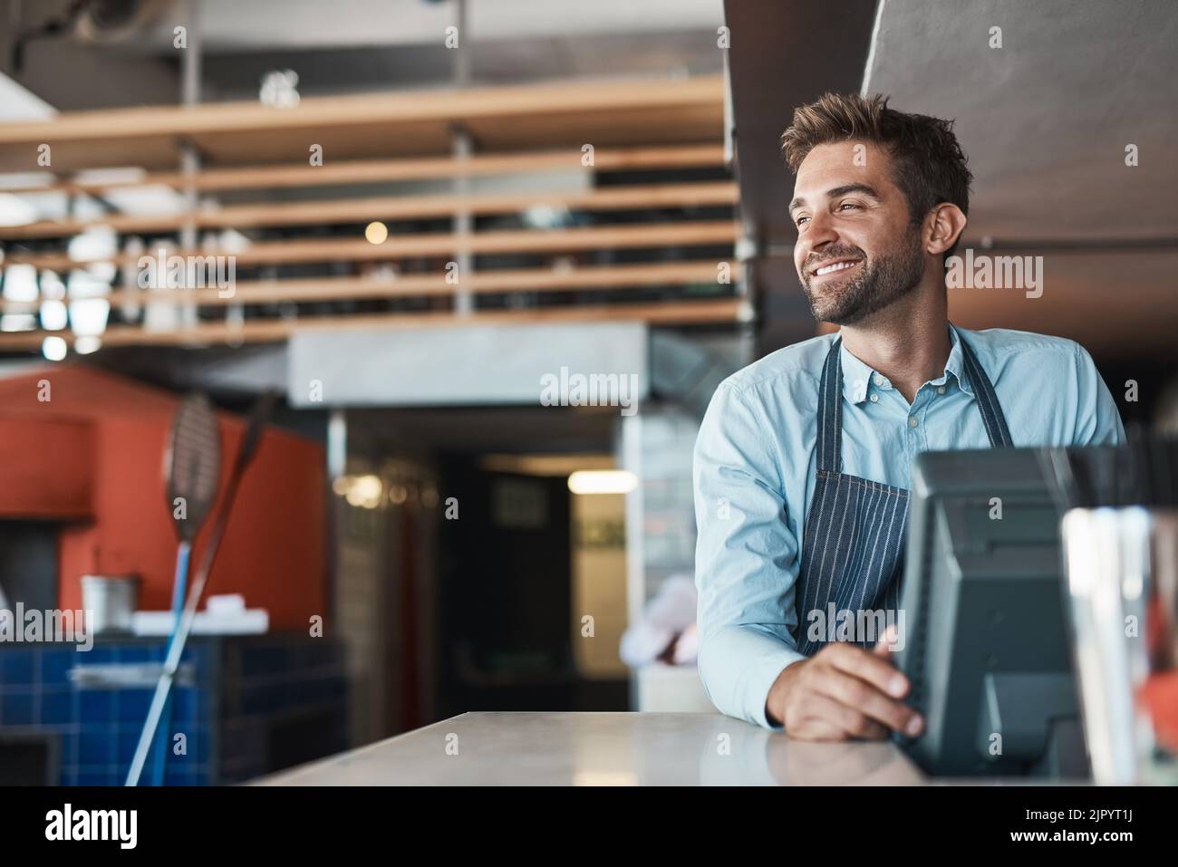 Making his coffeeshop dream come true. a young entrepreneur working in ...