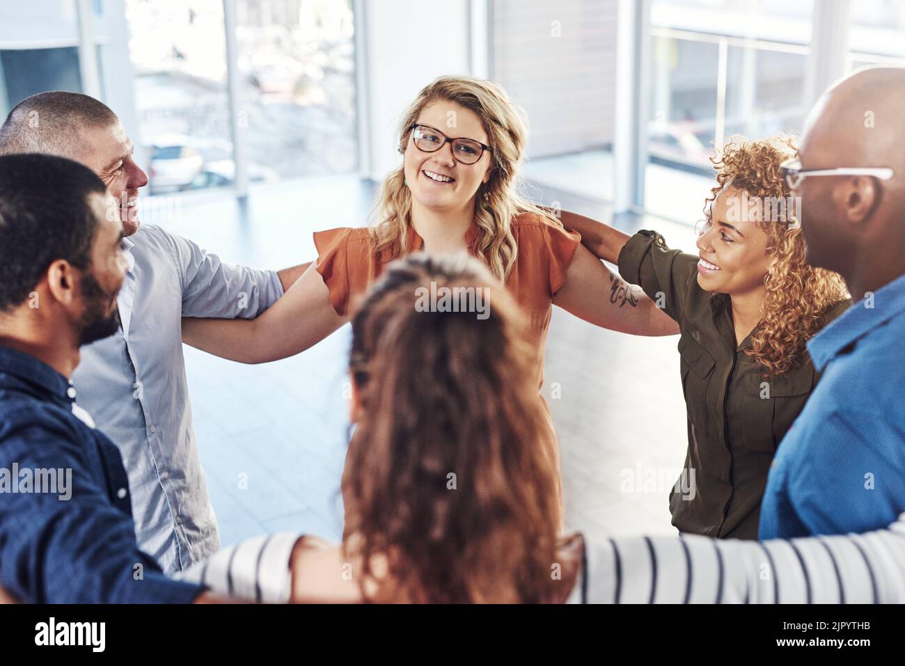 We uplift and support each other. a group of people standing in a ...