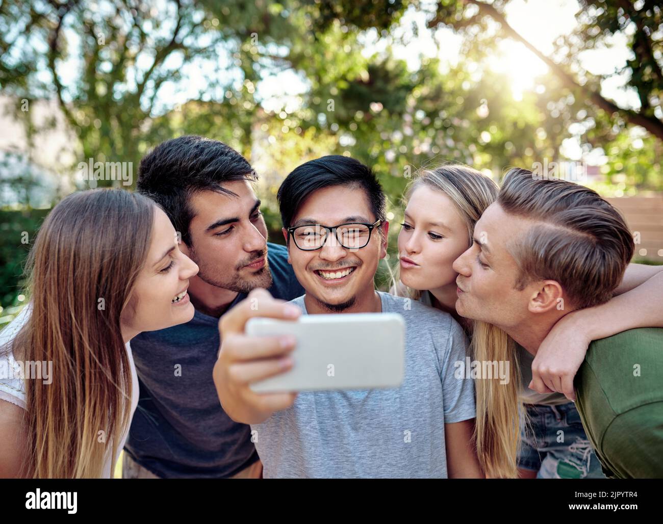 Spread the love. a young group of friends taking selfies while enjoying ...