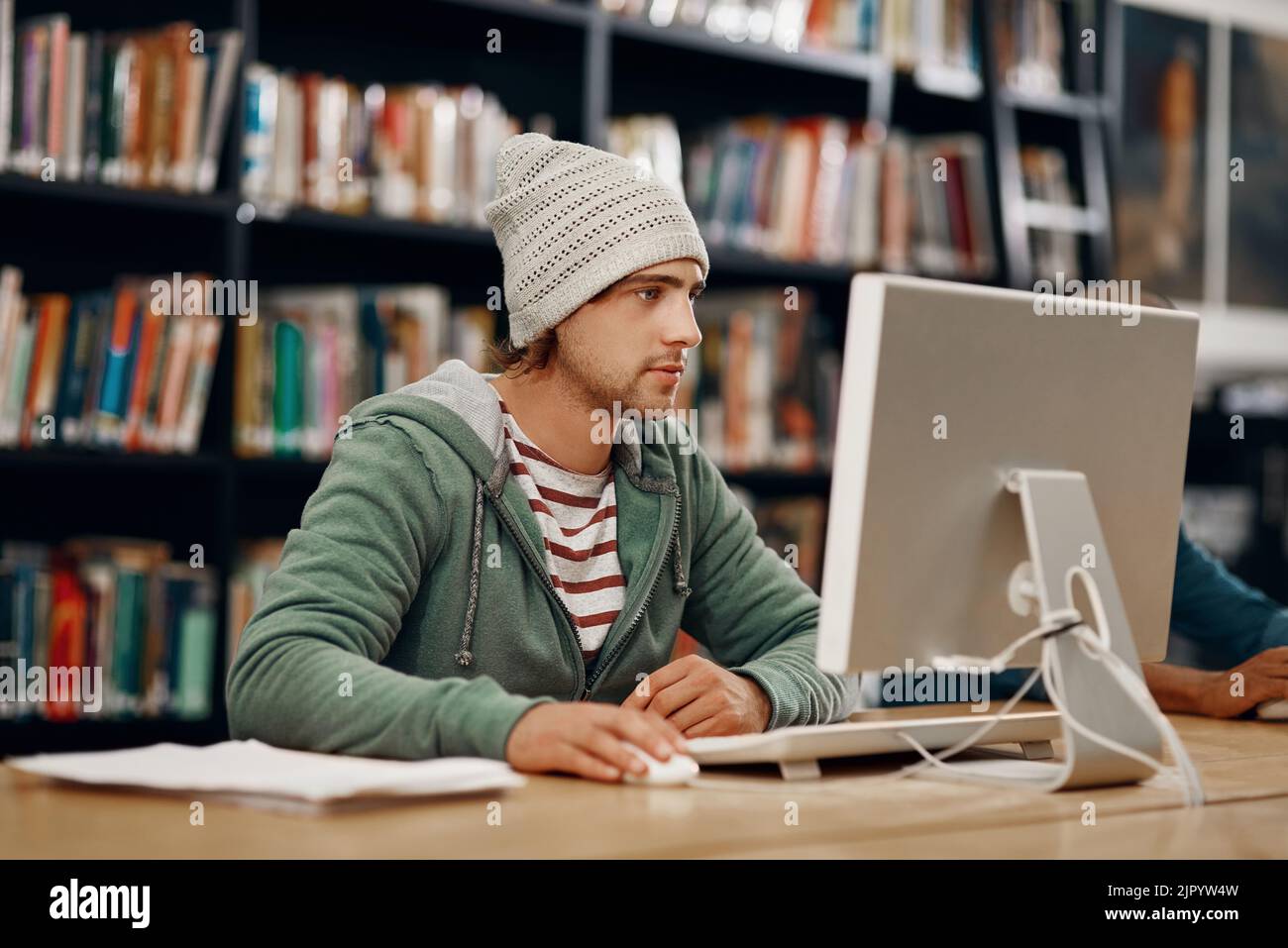 Focused on finals. a young male university student studying in the ... Focused on finals. a young male university student studying in the ...