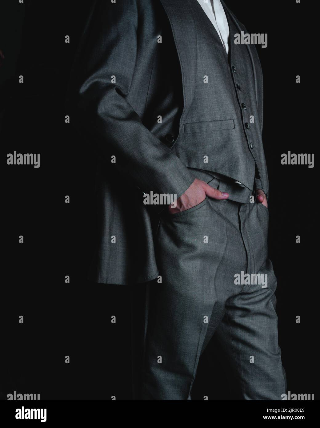 Man dressed in gray suit with his hands in his pockets. Man in a suit ...