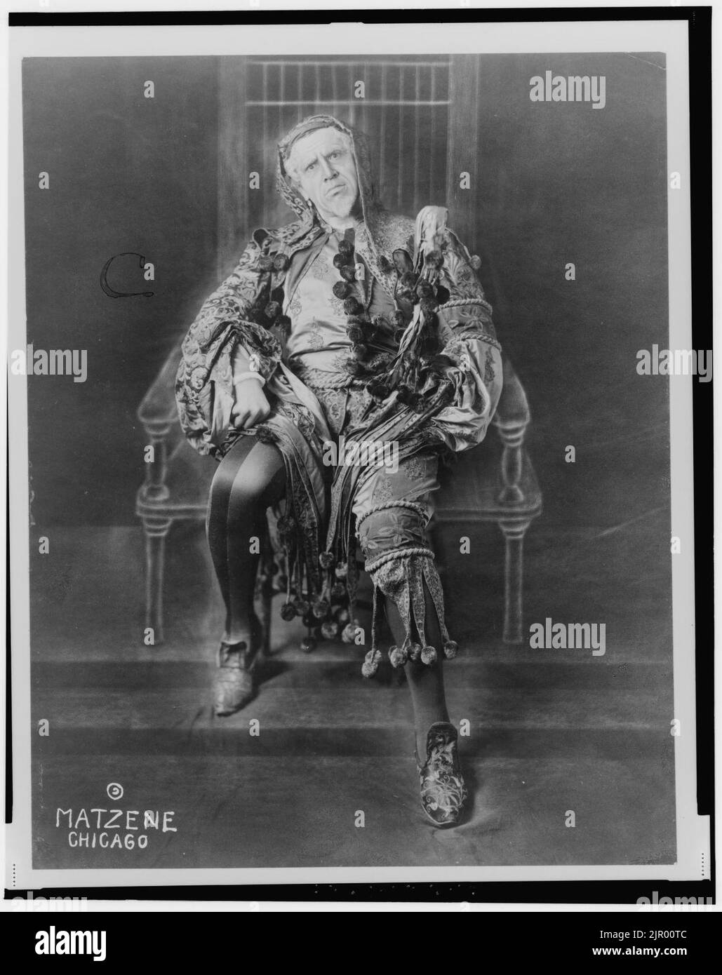 Titta Ruffo as Rigoletto, full-length portrait, facing front, seated in ...