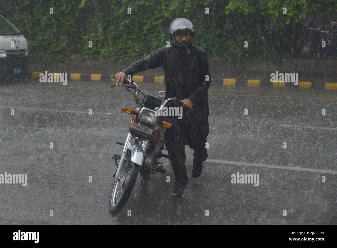 Lahore, Pakistan. 20th Aug, 2022. Pakistani people on their way during heavy monsoon rainfall ...