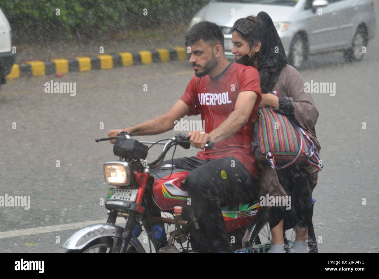 Lahore, Punjab, Pakistan. 20th Aug, 2022. Pakistani people on their way during heavy monsoon ...
