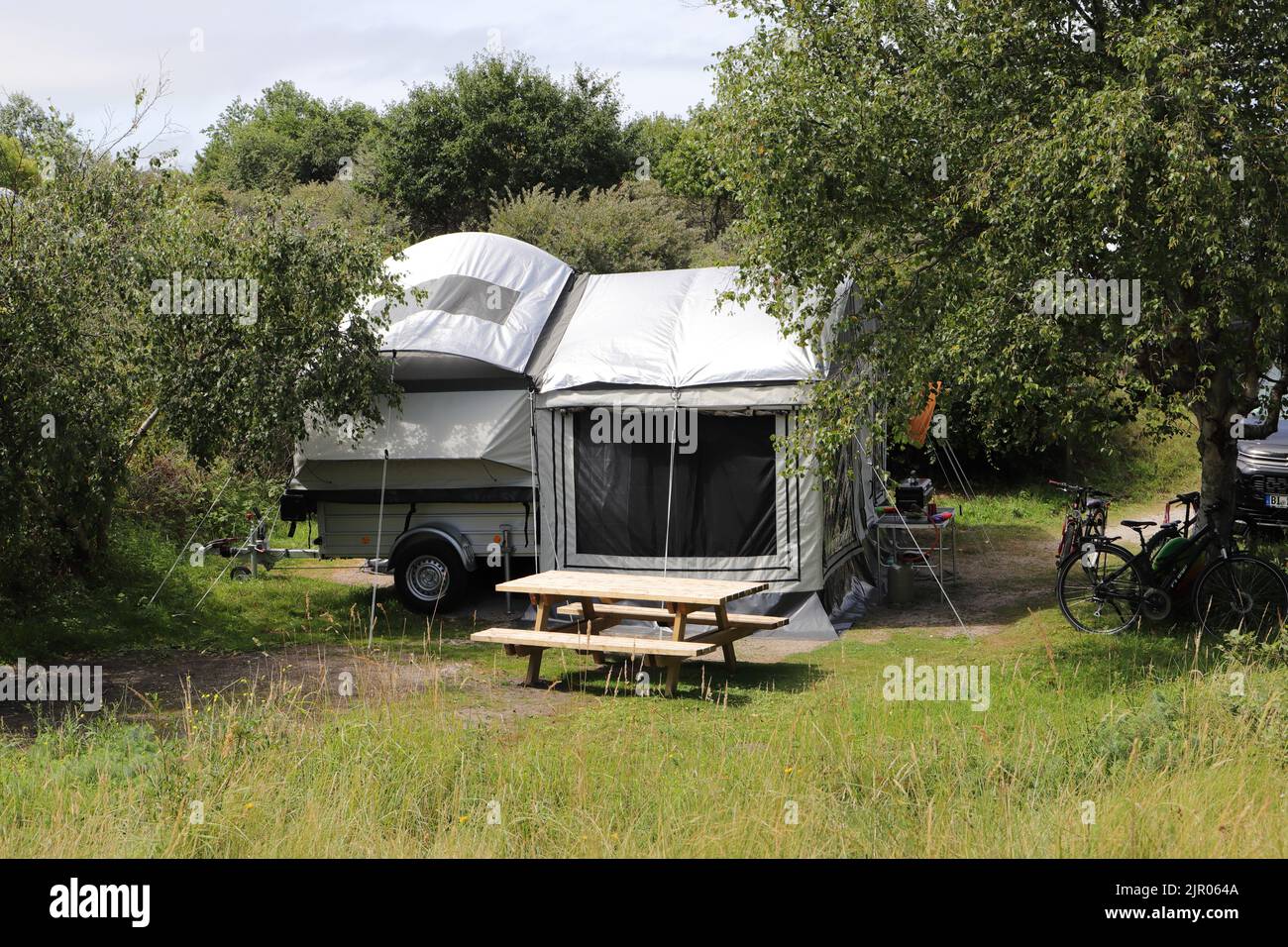 an old folding caravan on a campsite Stock Photo - Alamy