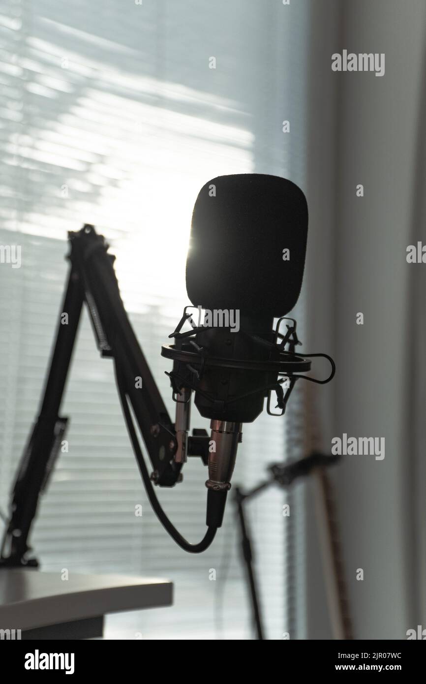 A vertical closeup of a microphone in a studio Stock Photo - Alamy