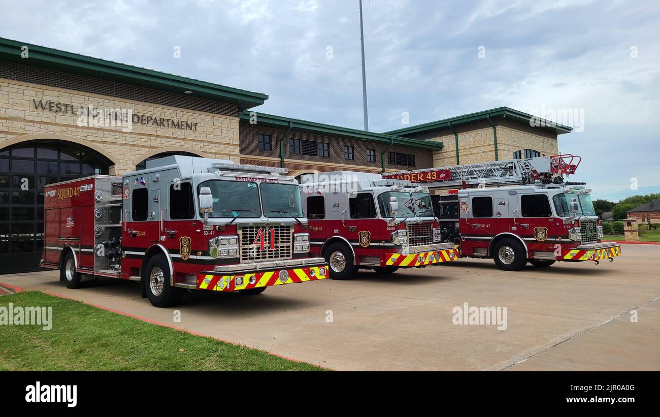 A line of red firefighting rescue trucks in front of the Westlake fire ...