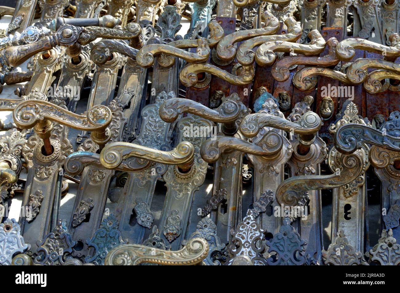 A closeup shot of antique brass door handles with delicate designs ...