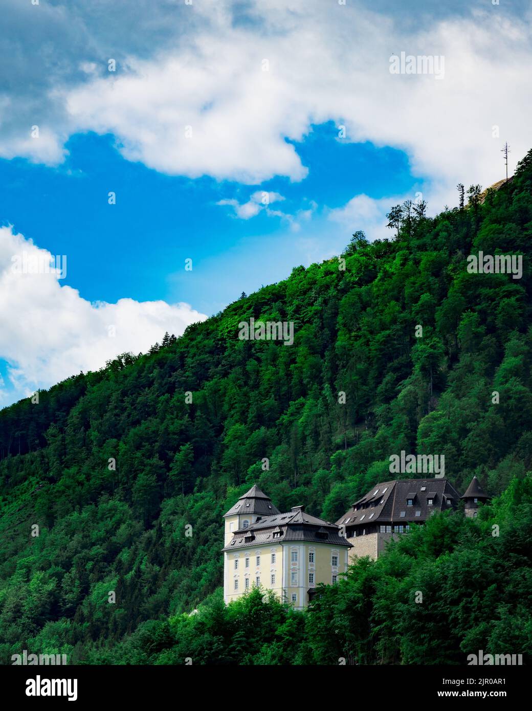 Scenic cloudy sky over green hill with the famous Klaus castle, Austria ...