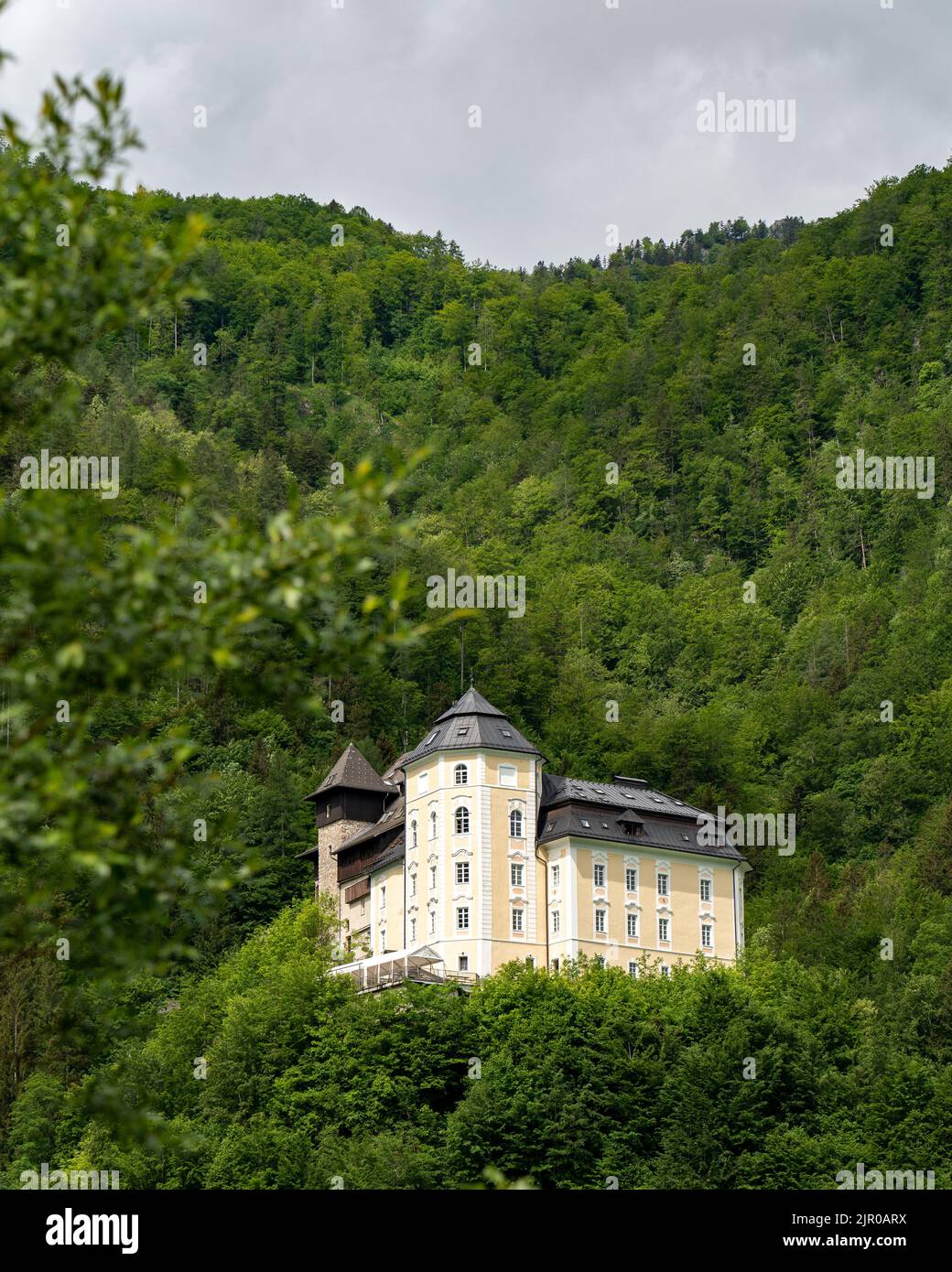 The famous Klaus castle on a hilltop, surrounded by deciduous green ...