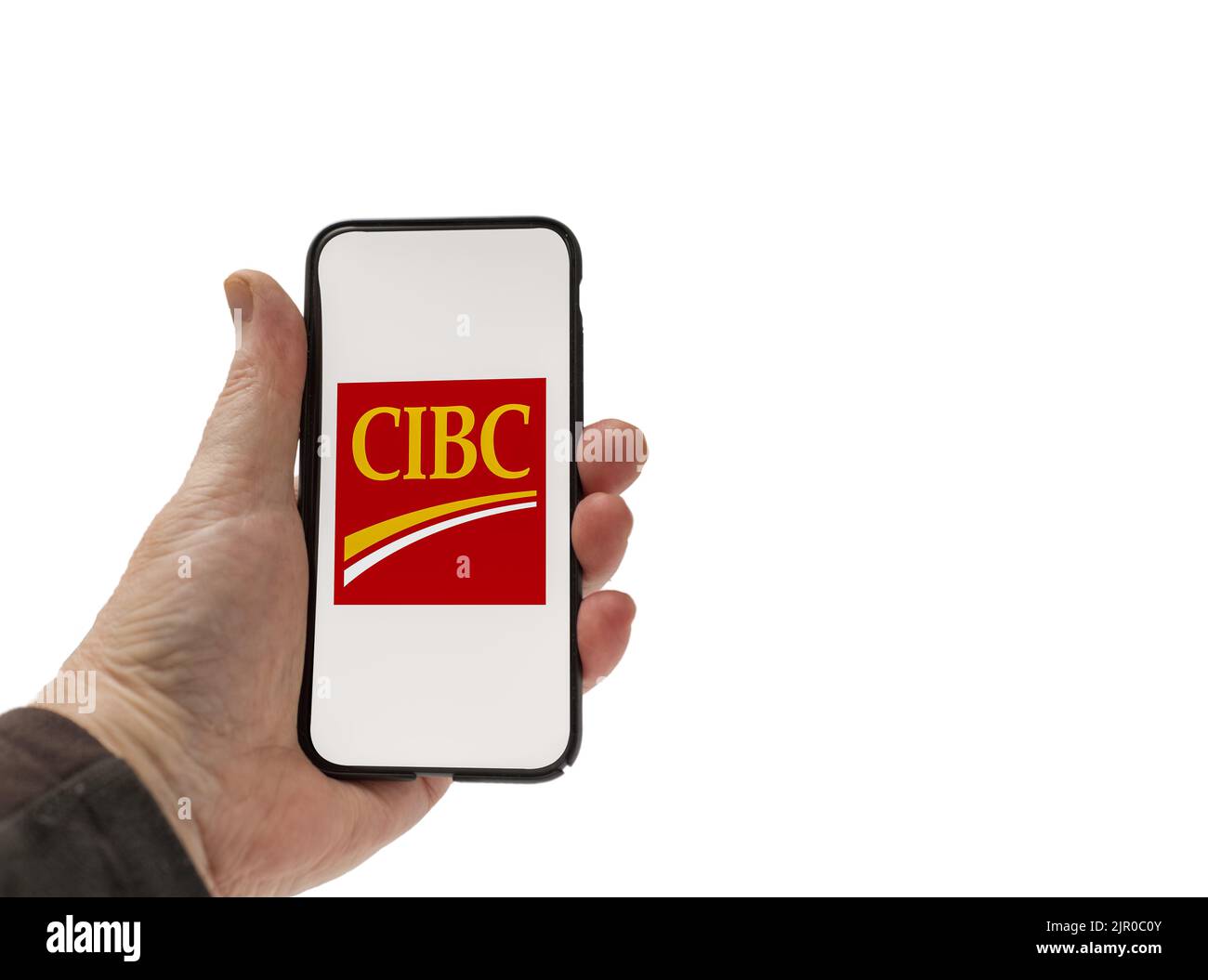 Cardiff Mid Glamorgan UK August 20 2022 person holding cellphone with CIBC Logo on a white ...