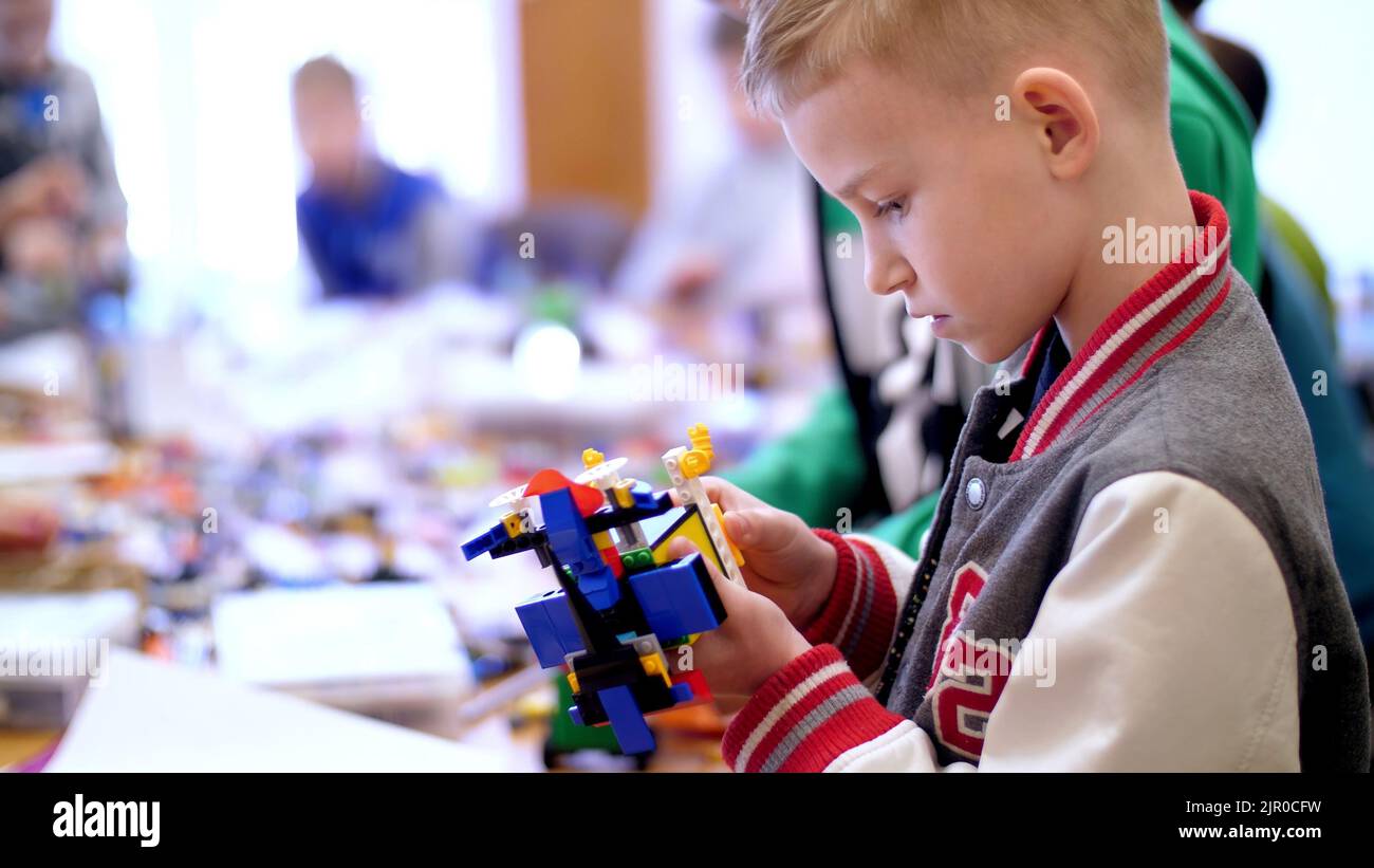 the boy of 10 years, plays in the designer from cubes, plates, circuits ...