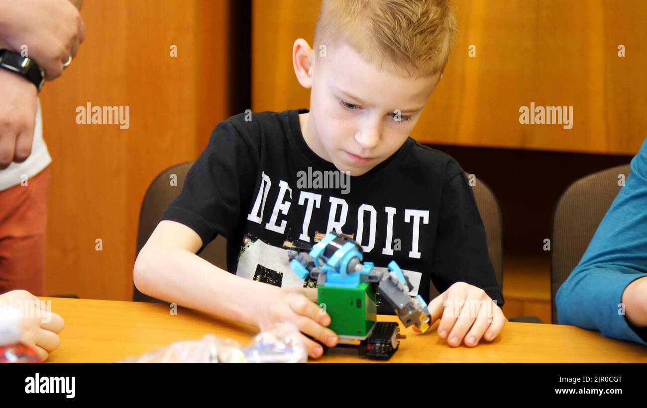 the boy of 9 years, plays in the designer from cubes, plates, circuits ...