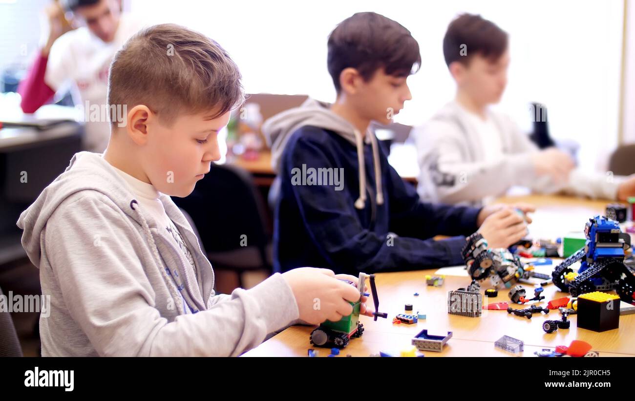 boys of 12 years, play in the designer from cubes, plates, circuits ...