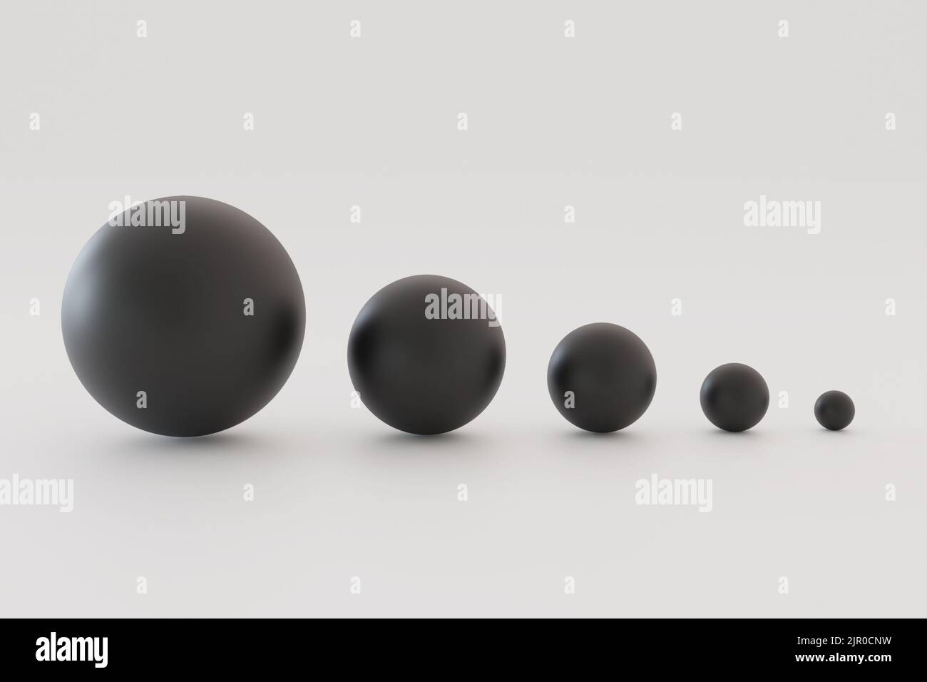 Five black balls of different sizes. balls of different sizes on a ...