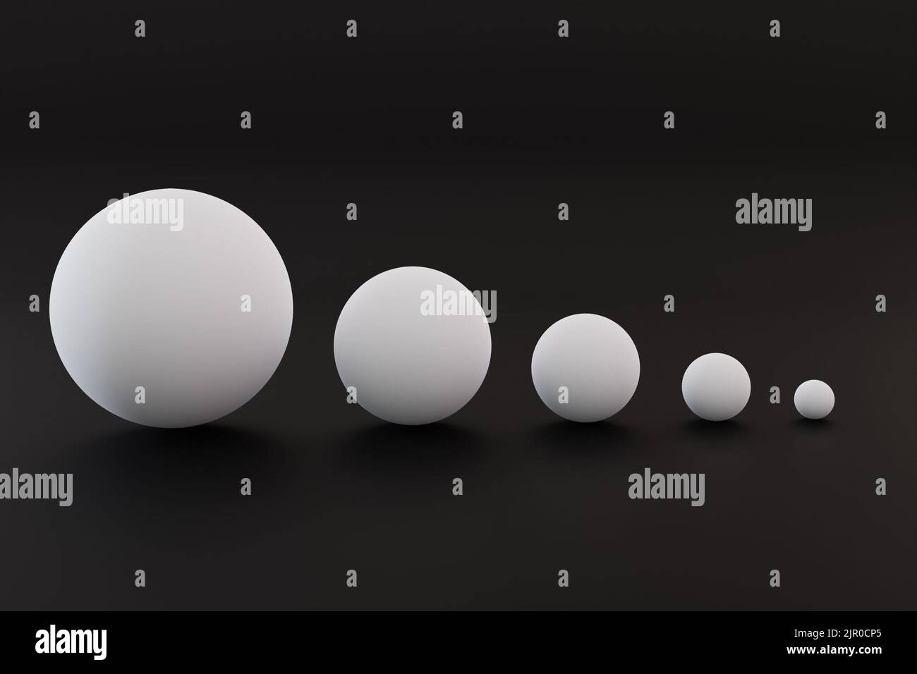 Five white balls of different sizes. balls of different sizes on a ...