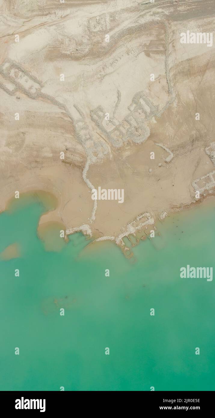 Overhead drone view of of the ruins resurfaced from the bottom of a ...