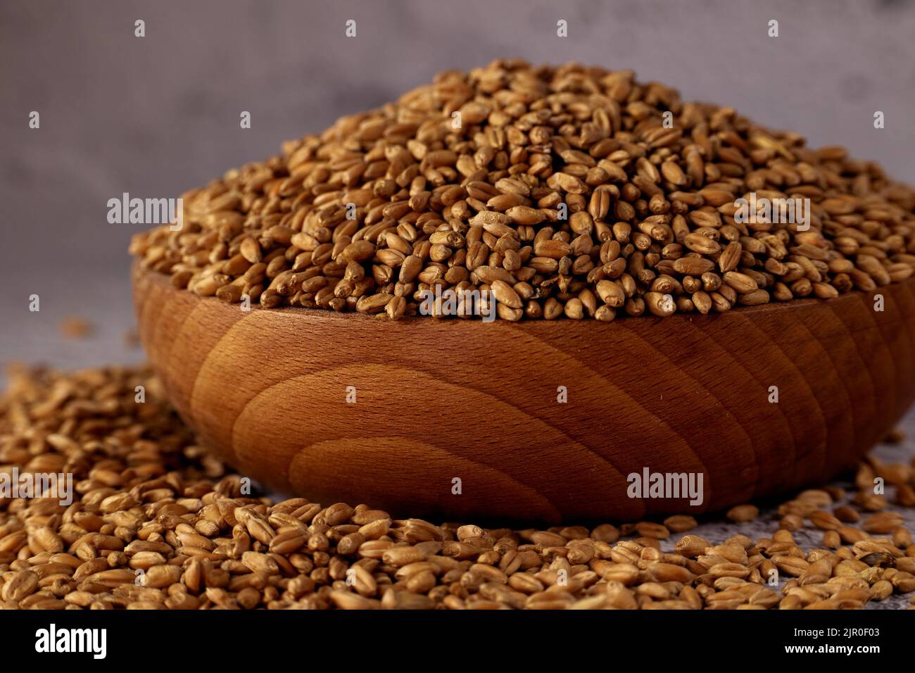 Macro photo of a mountain of wheat grains in a wooden bowl Stock Photo ...
