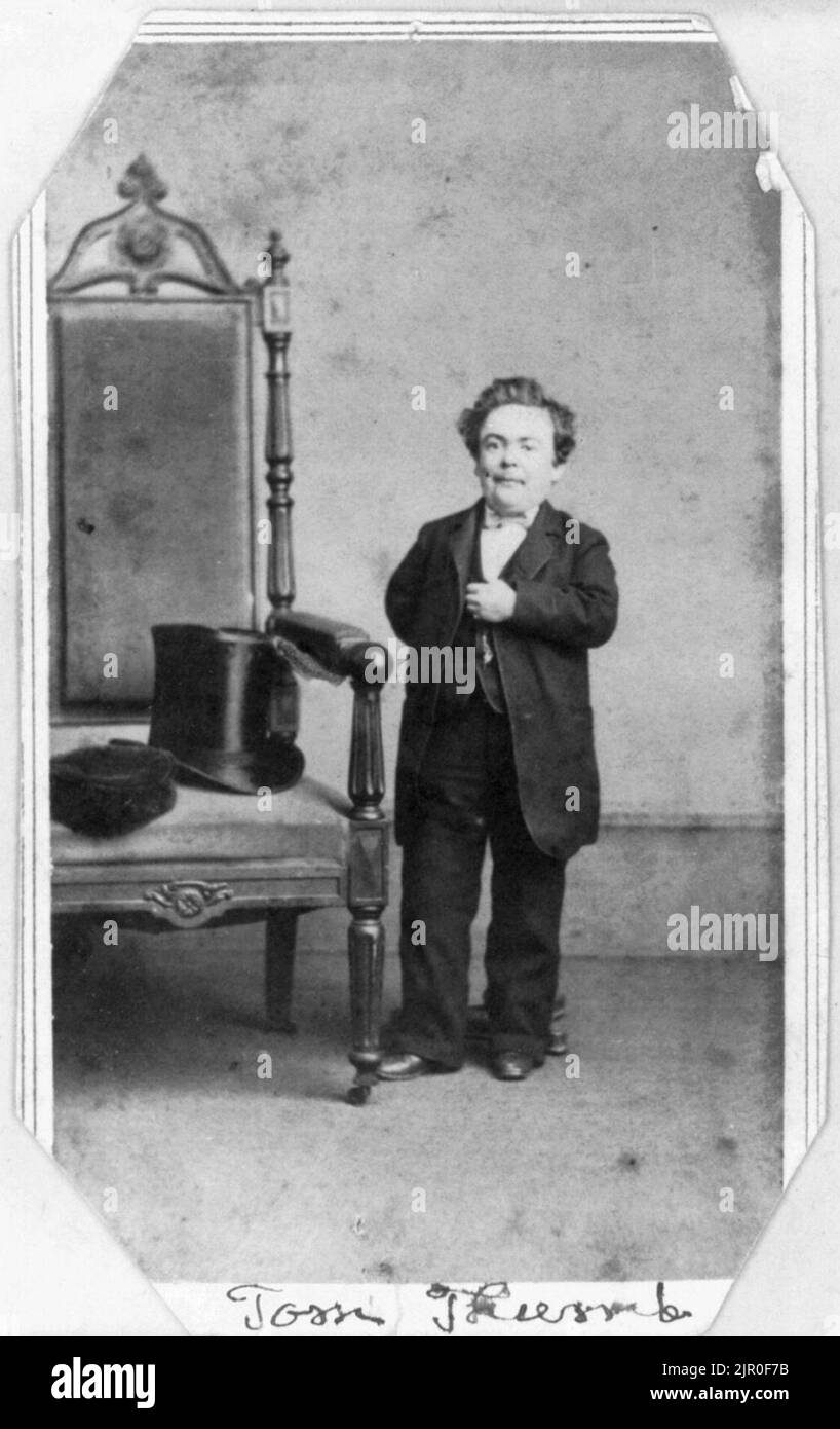 Tom Thumb, full-length portrait, facing left, standing by chair Stock ...
