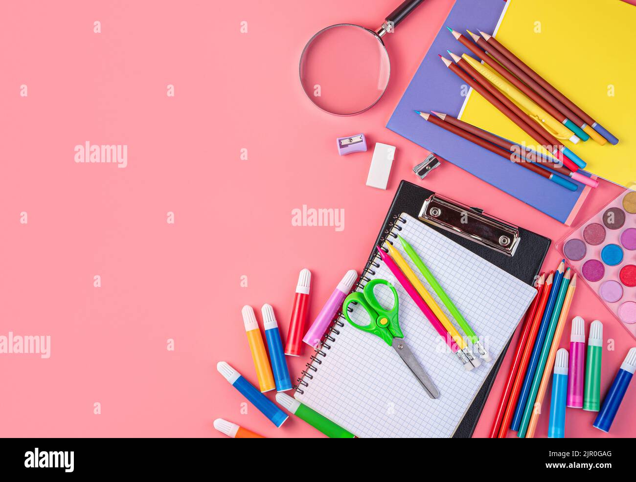 Stationery and school supplies on a pink background with space for ...