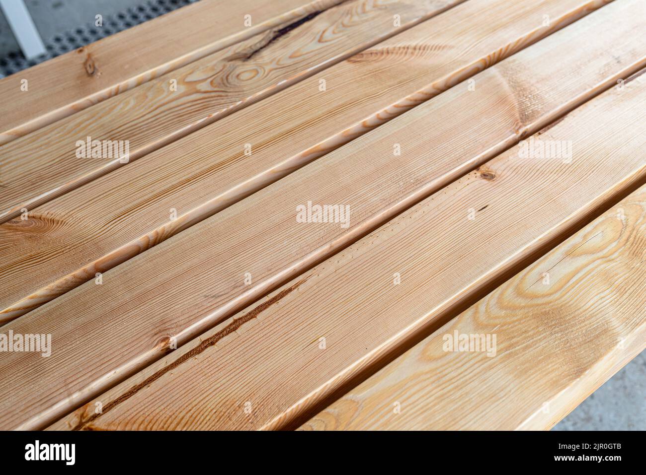 Raw planed pine wooden beams, dimensions 100x100mm, lying next to each ...
