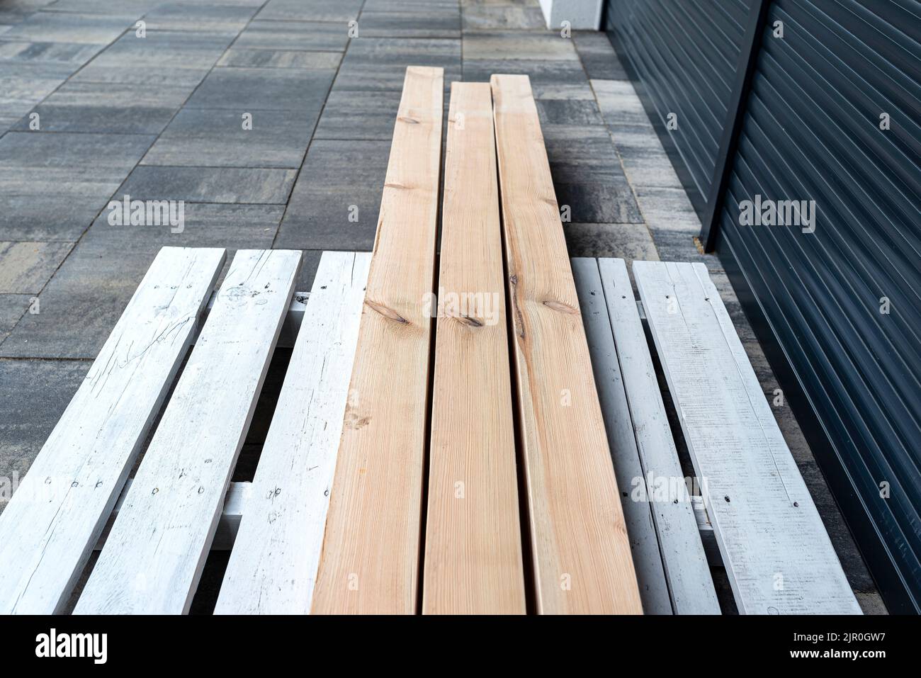 Raw planed pine wooden beams, dimensions 100x100mm, lying next to each ...