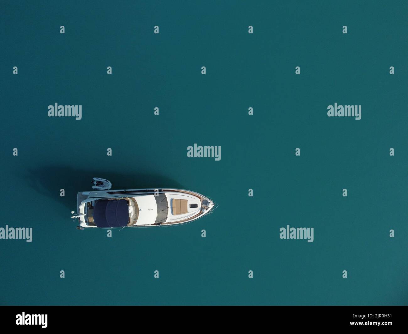 Aerial yacht on calm sea. Luxury cruise trip. View from above of white ...