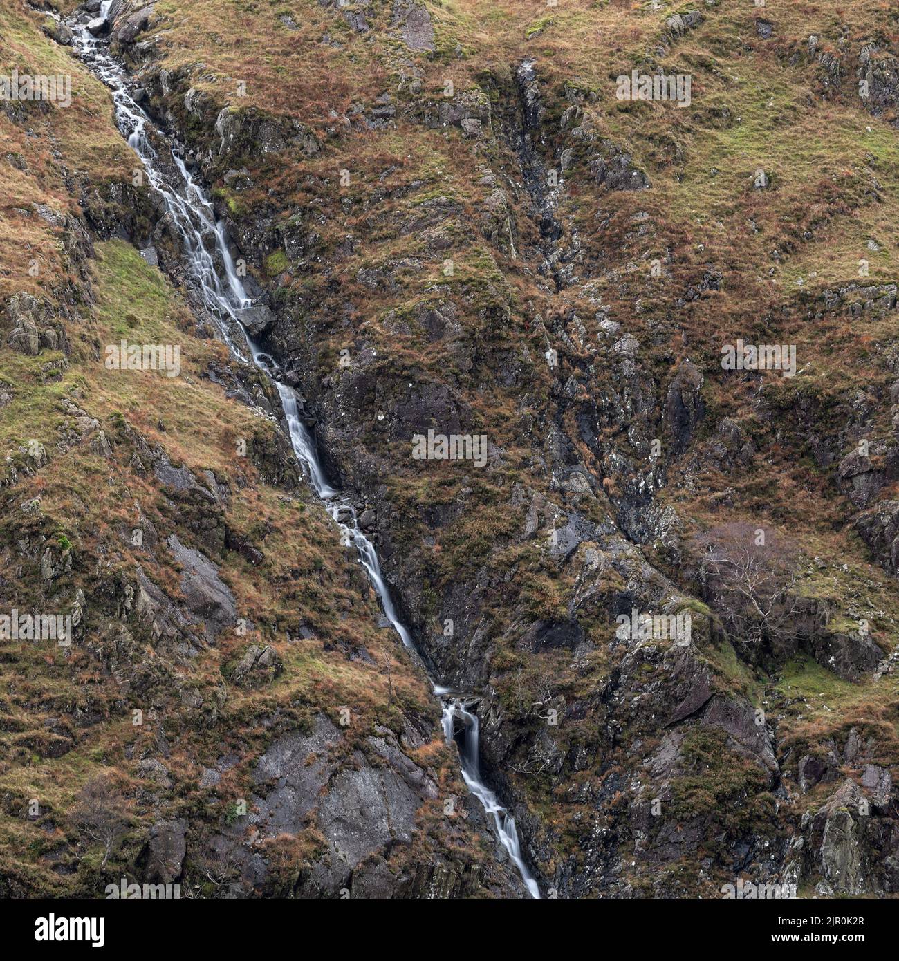 Epic landscape image of mountain stream on the side of Fleetwith Pike ...